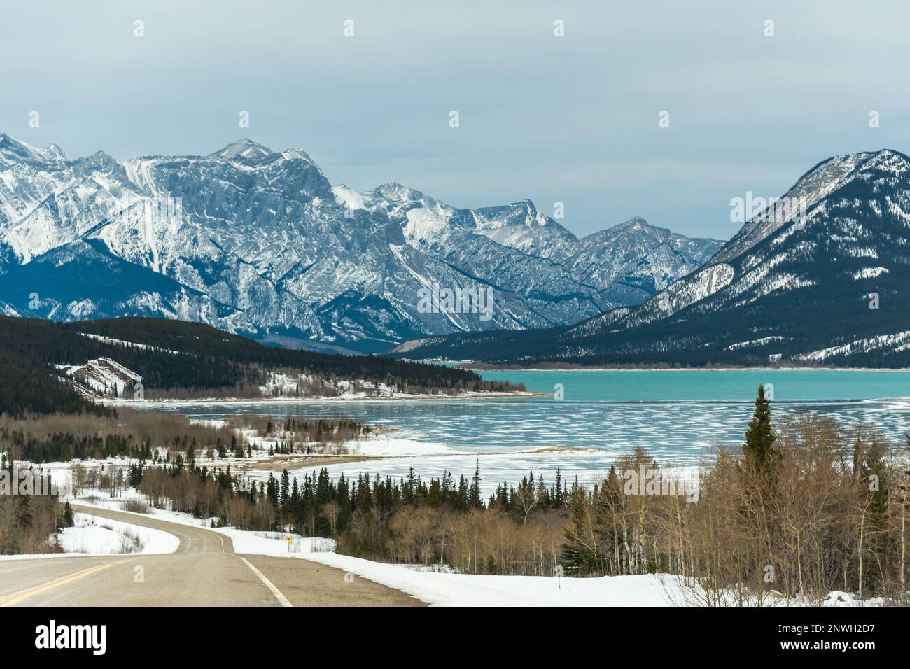 Wilderness road, highway in northern Canada with mountains towering ...