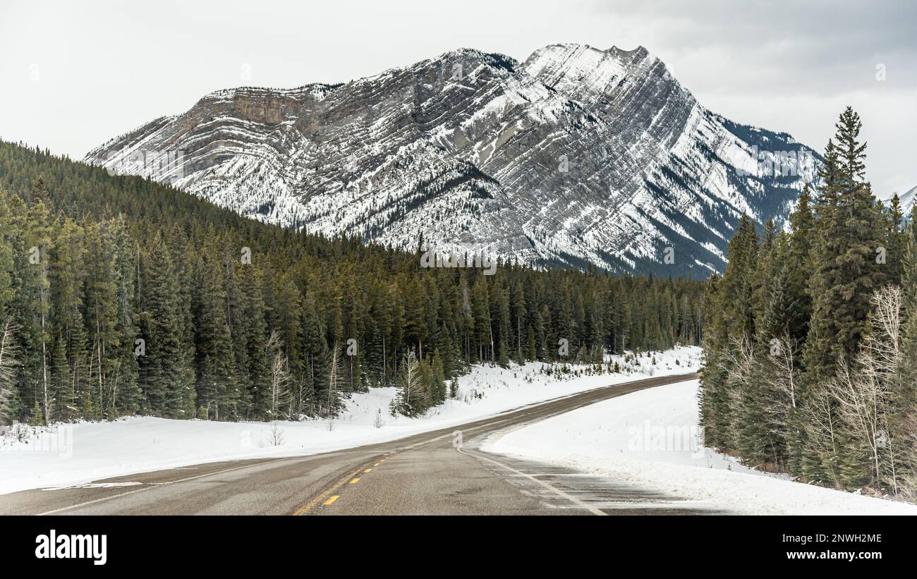 Wilderness road, highway in northern Canada with mountains towering ...