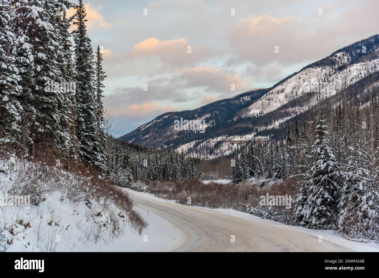 Wilderness road, highway in northern Canada with mountains towering ...