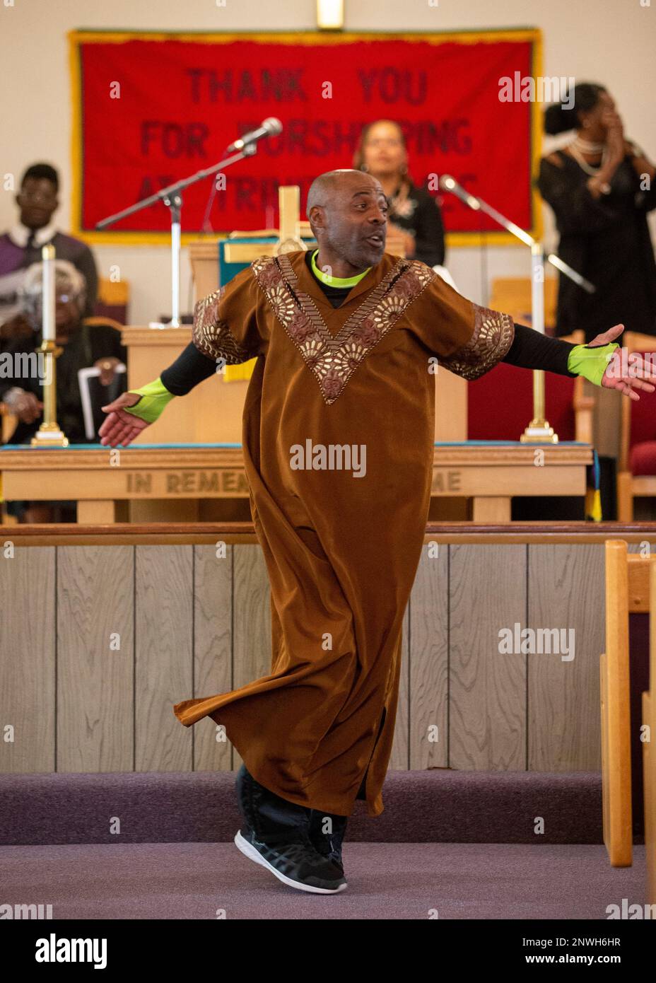 Brother Kevin Nelson performs a Praise dance as members of Trinity A.M ...
