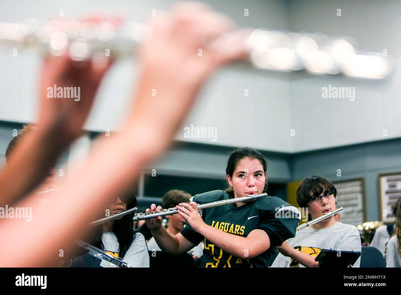 Varsity football player Julliana Michael, 13, practices the flute with ...