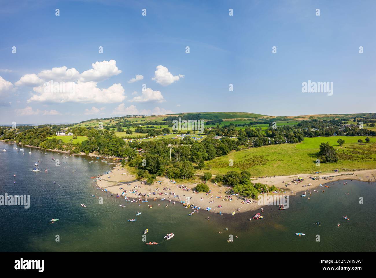 Aerial view of a crowded beach on the shore of a large lake in summer ...