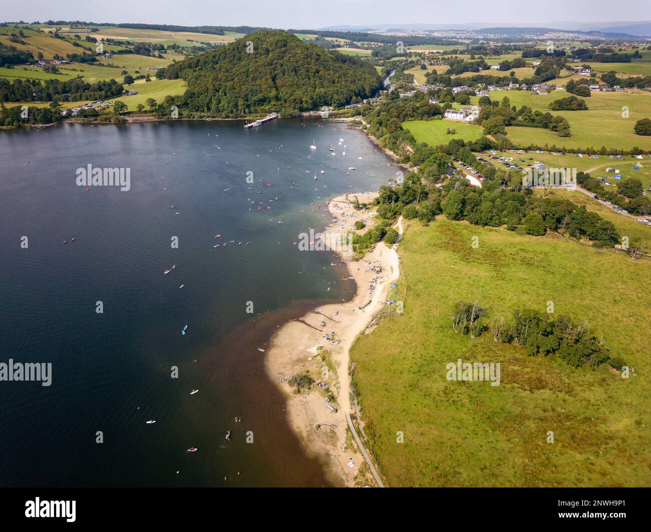 Aerial view of a crowded beach on the shore of a large lake in summer ...
