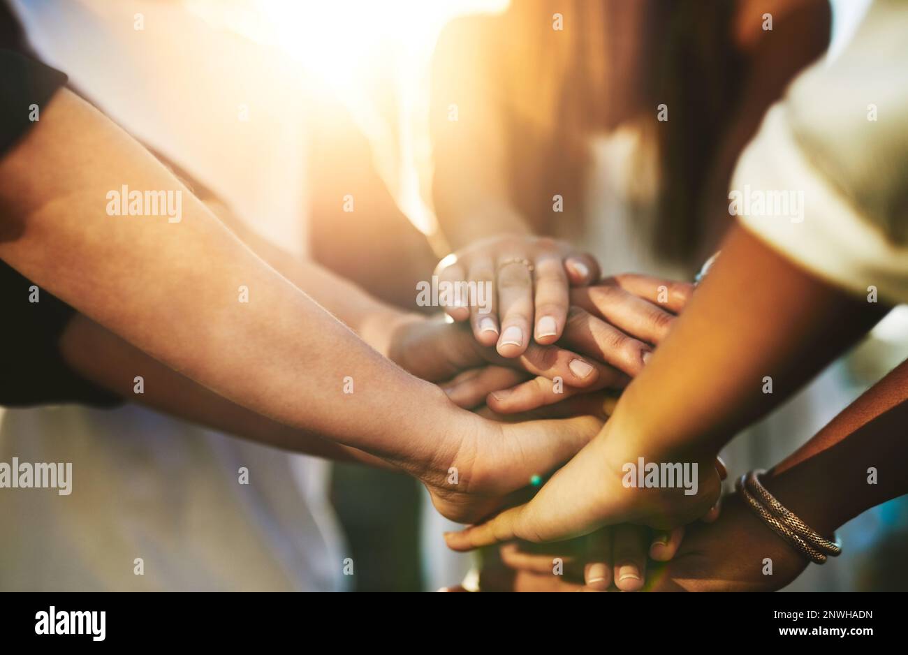 Team support. Cropped shot of an unrecognizable group of people putting ...