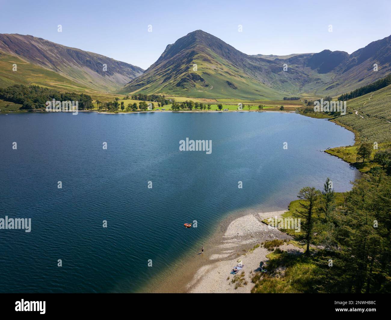 Aerial view of a beautiful lake and small beach in a rural valley ...