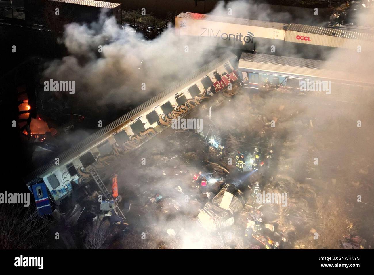 Smoke rises from trains as firefighters and rescuers operate after a ...
