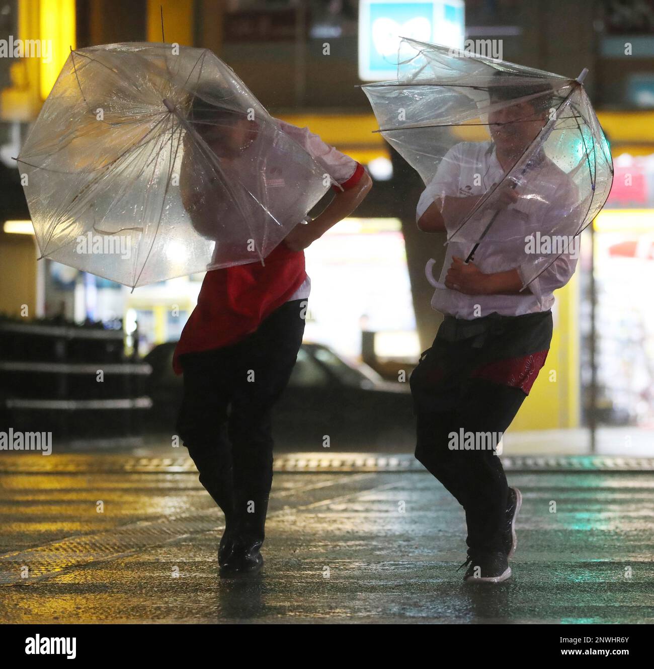 People walk while heavy rain and strong wind in Toshima Ward, Tokyo on ...