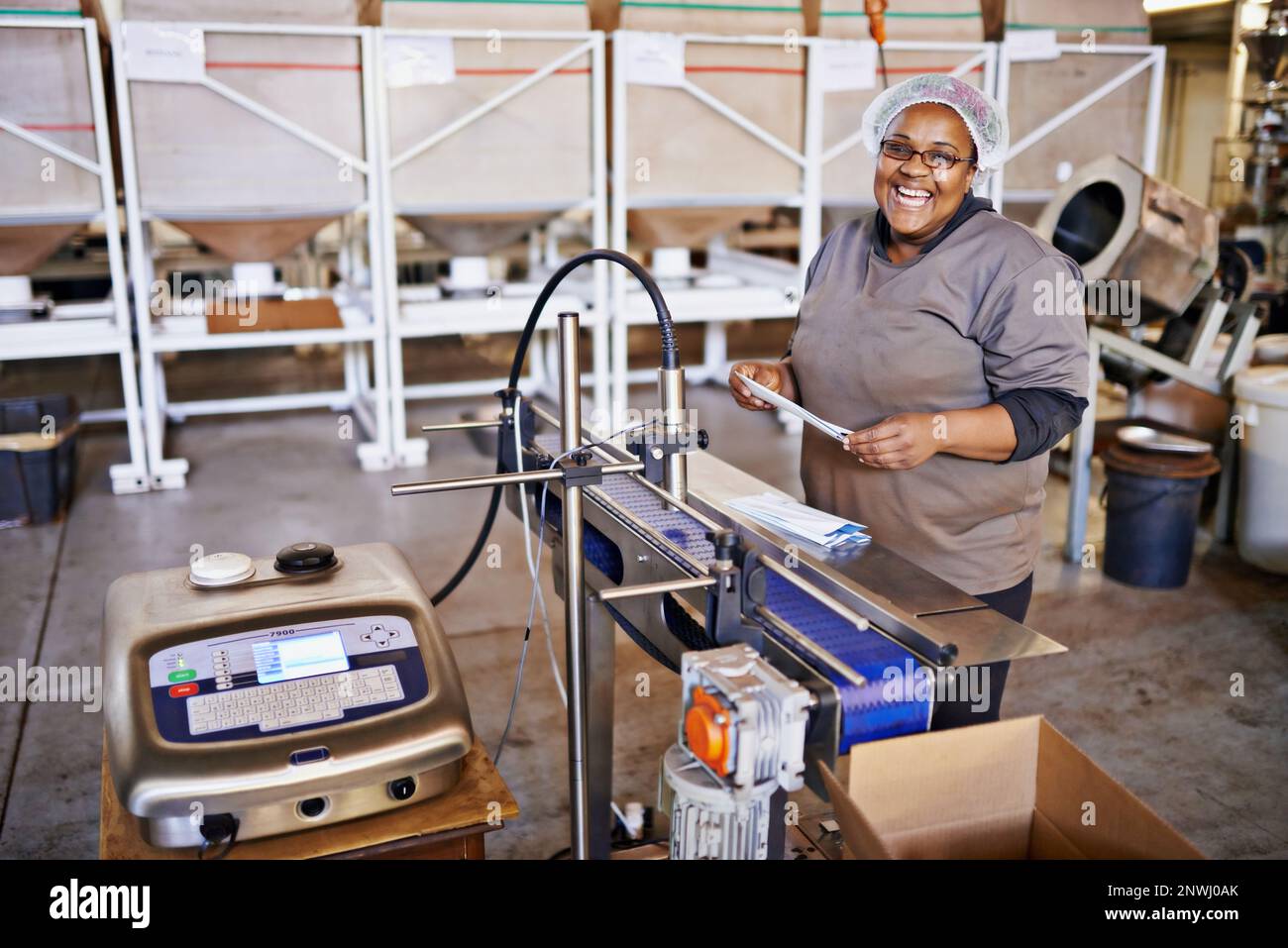 Weighed up for profit. Shot of a factory worker using an industrial ...