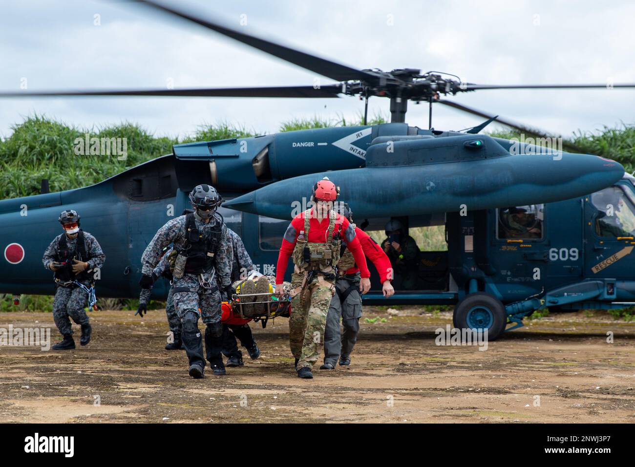 Japan Air Self-Defense Force and U.S. Air Force pararescuemen carry a ...