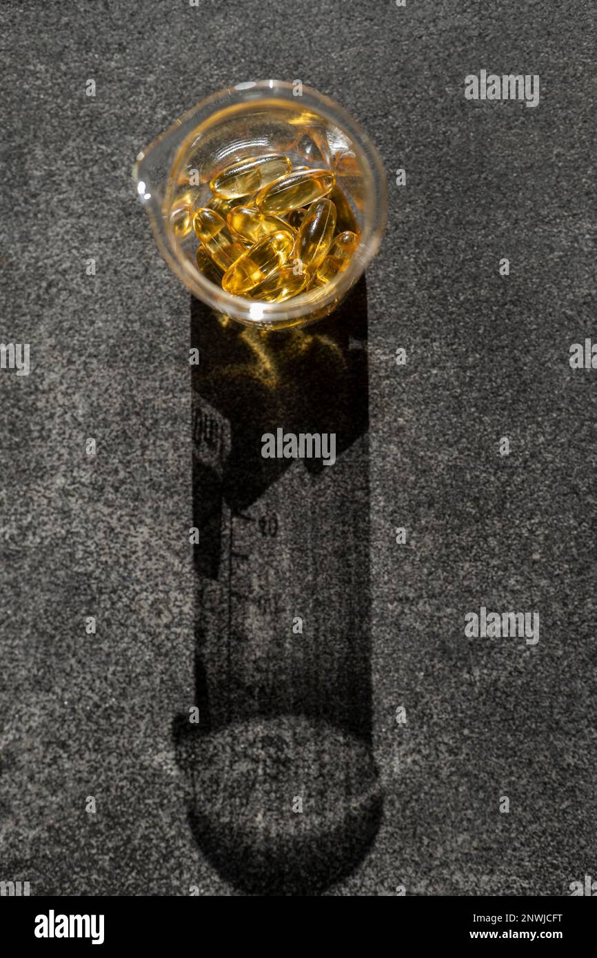 Cod Liver Oil. Omega-3.Fish oil capsules in transparent laboratory ...