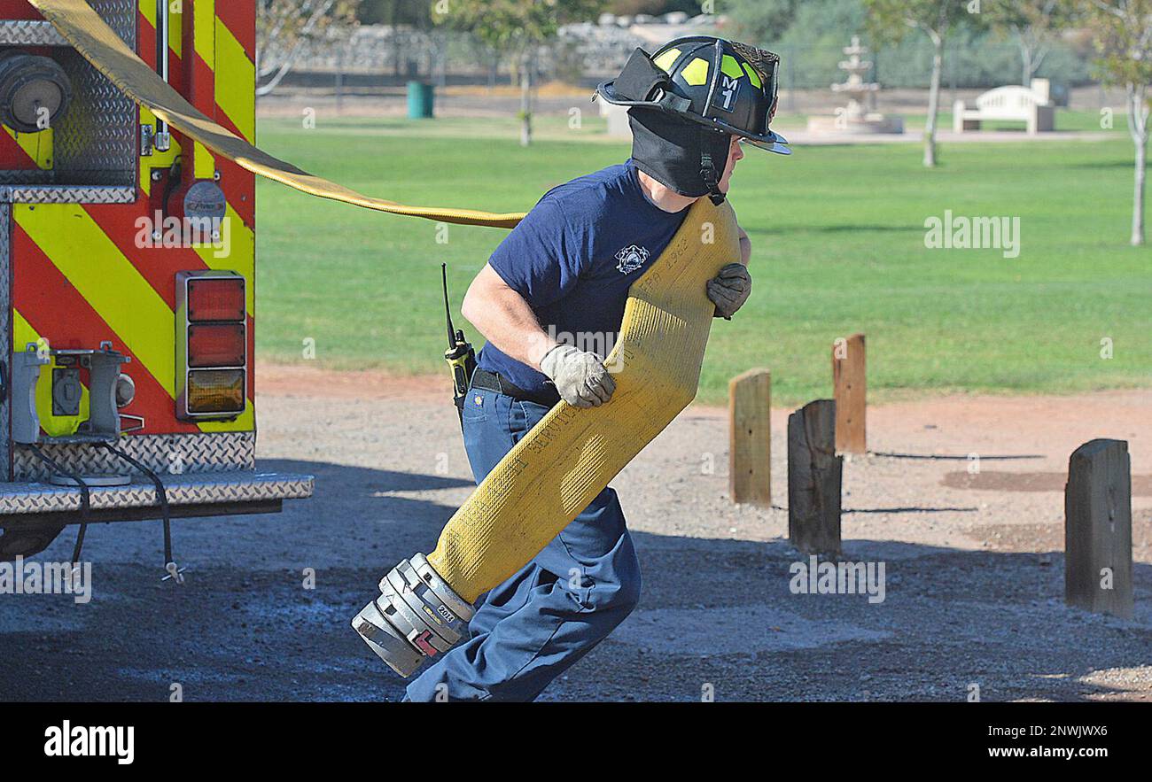 Yuma Fire Department rookie firefighter Matthew Dodt carries a five ...