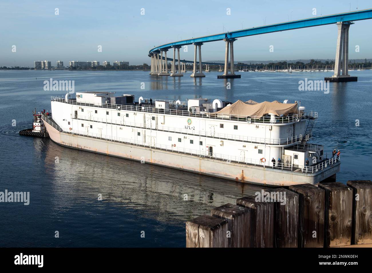 SAN DIEGO (Jan. 13, 2023) A tugboat tows a barge (APL-2), assigned to ...