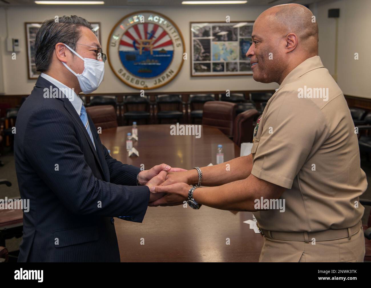 Capt. David Adams, Commander, Fleet Activities Sasebo (CFAS), shakes ...