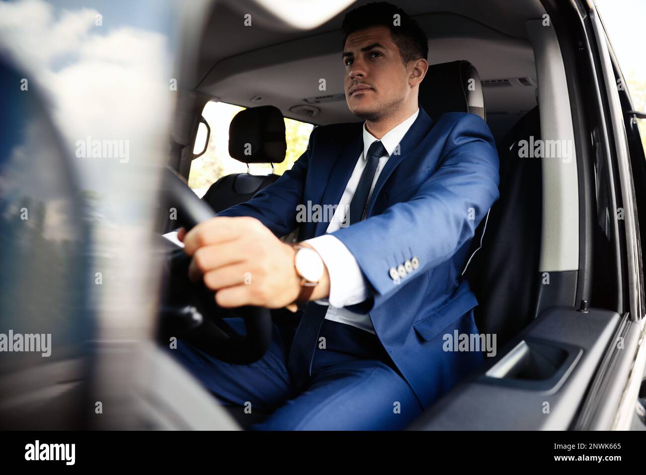 Handsome man driving his modern luxury car Stock Photo - Alamy