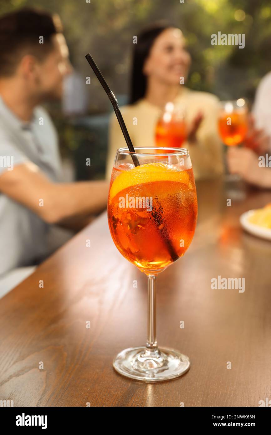 Friends spending time together at cafe, focus on Aperol spritz cocktail ...