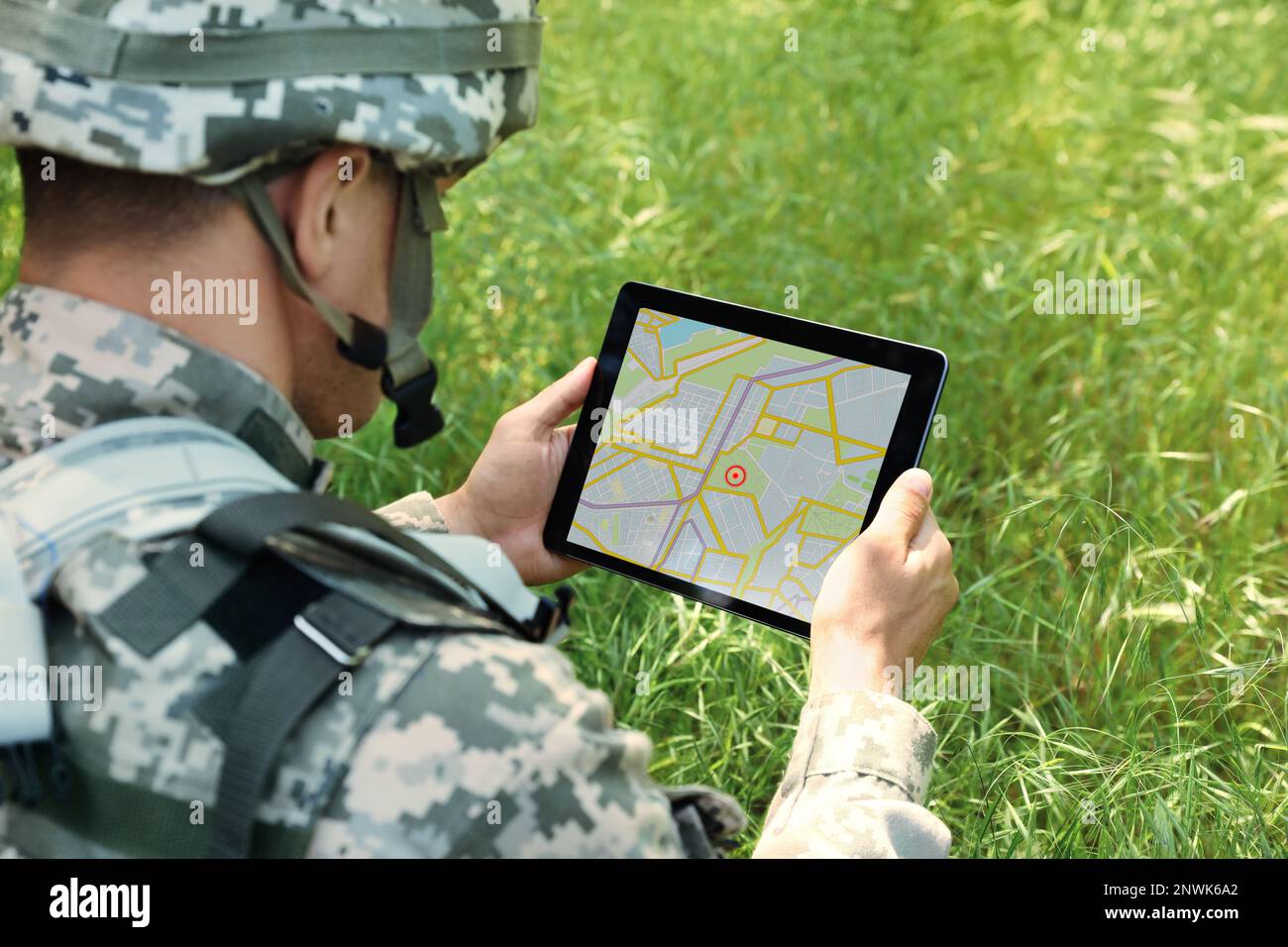 Soldier using tablet in forest. Modern technology Stock Photo - Alamy