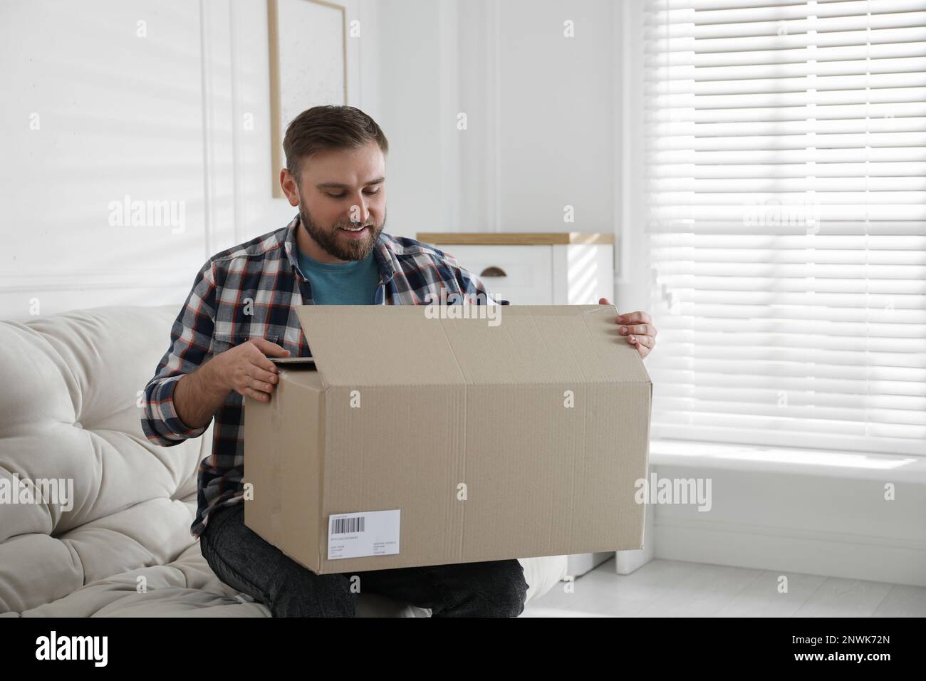 Happy customer opening parcel hi-res stock photography and images - Alamy