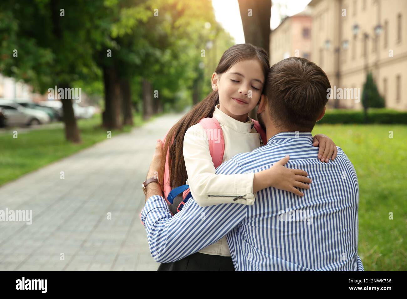Father hugging his little daughter before school outdoors Stock Photo ...