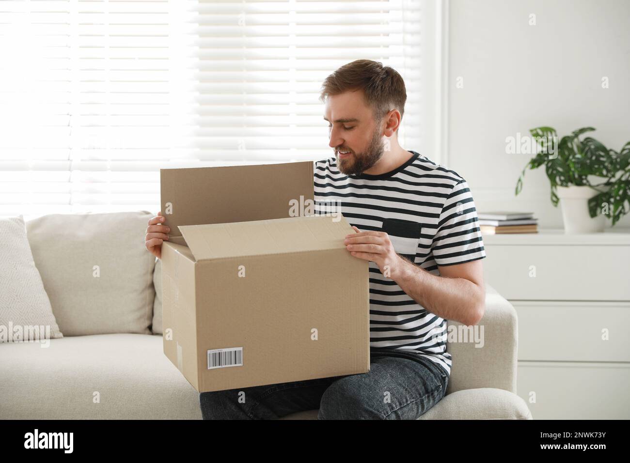 Happy customer opening parcel hi-res stock photography and images - Alamy