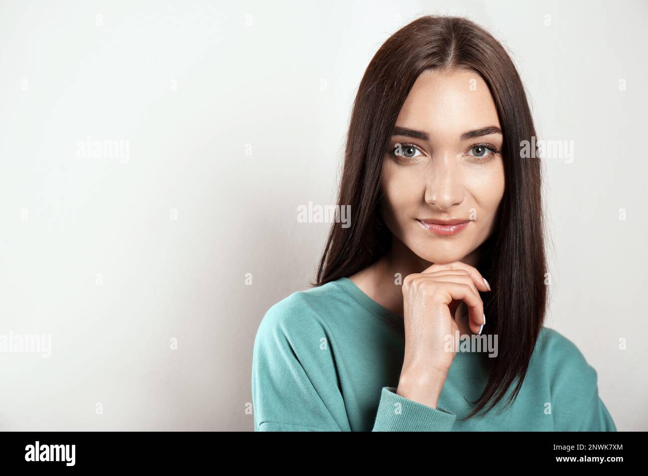 Portrait of pretty young woman with gorgeous chestnut hair on light ...