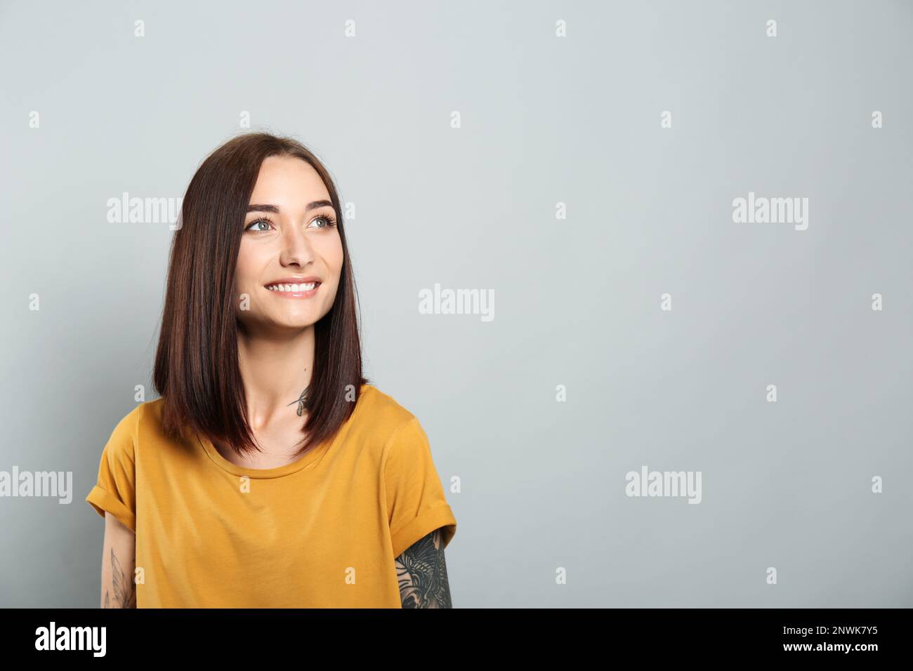 Portrait of pretty young woman with gorgeous chestnut hair and charming ...