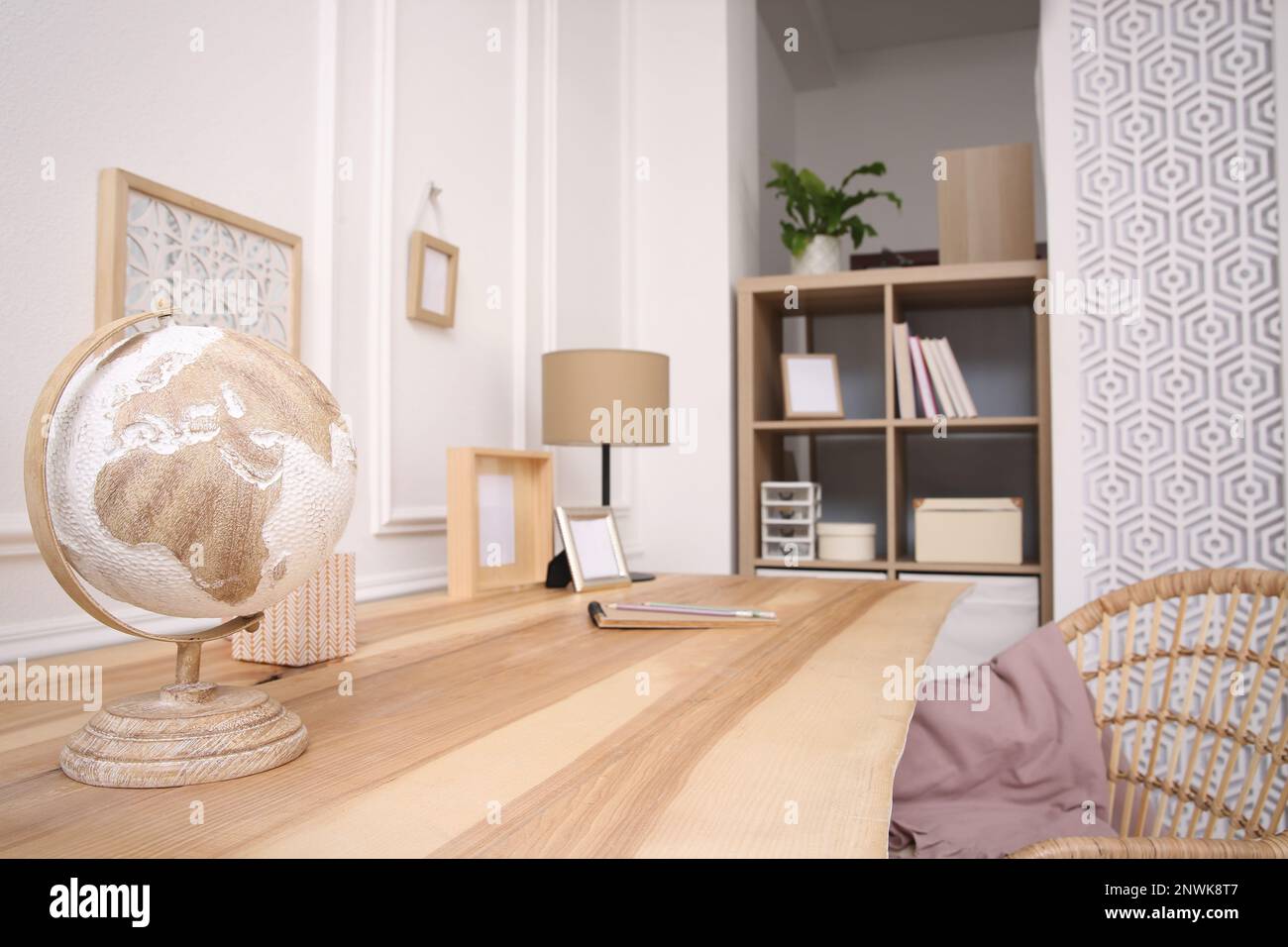 Wooden table with desk lamp in room. Interior design Stock Photo - Alamy