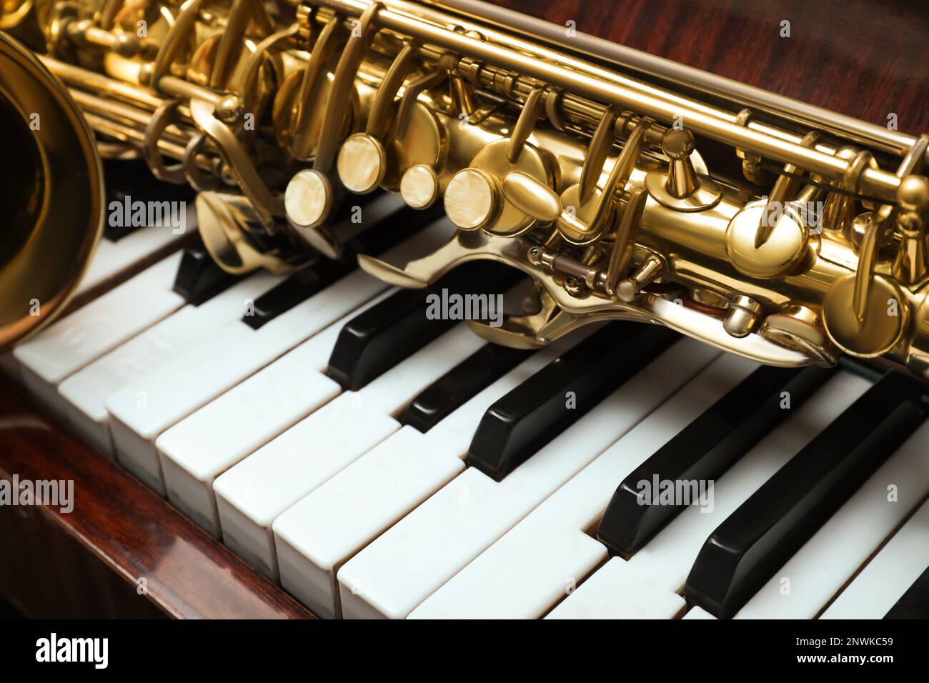 Beautiful saxophone on piano keys, closeup. Musical instruments Stock ...