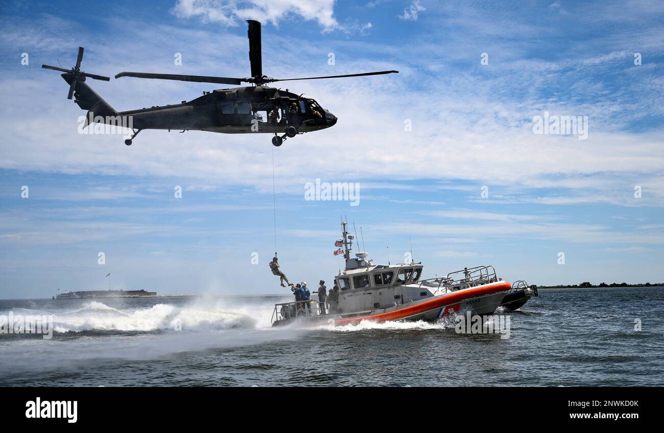 An H-60 M Black Hawk lowers a FBI Hostage Rescue Team Member while ...