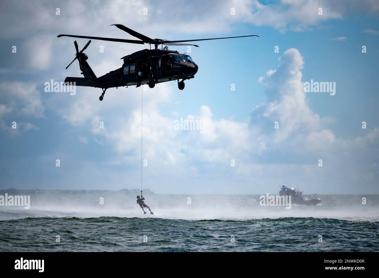 A member of the FBI’s Hostage Rescue team prepares to hoist lifeguards ...