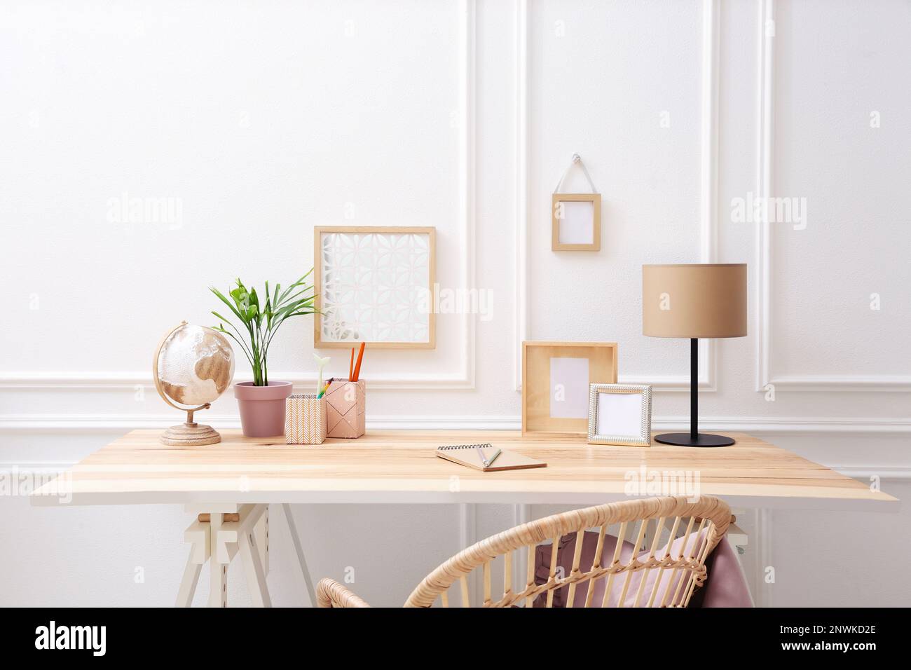 Wooden table with desk lamp in room. Interior design Stock Photo - Alamy