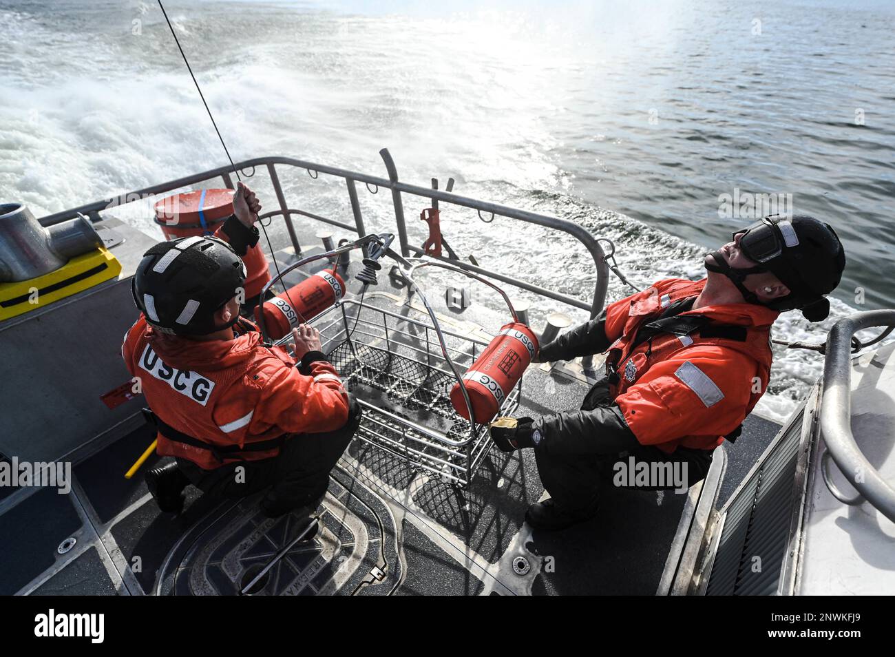 U.S. Coast Guard Seaman Eric Buckle, left, and Boatswains Mate 3rd ...