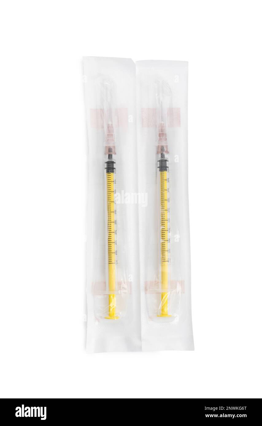 Packed disposable syringes with needles on white background, top view ...