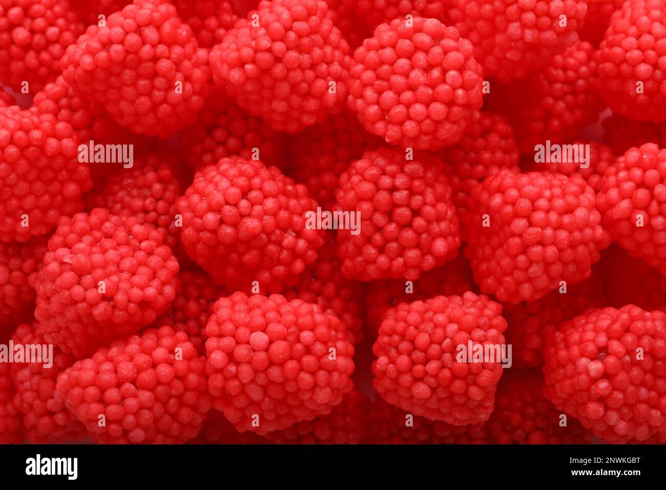 Delicious gummy raspberry candies as background, top view Stock Photo ...