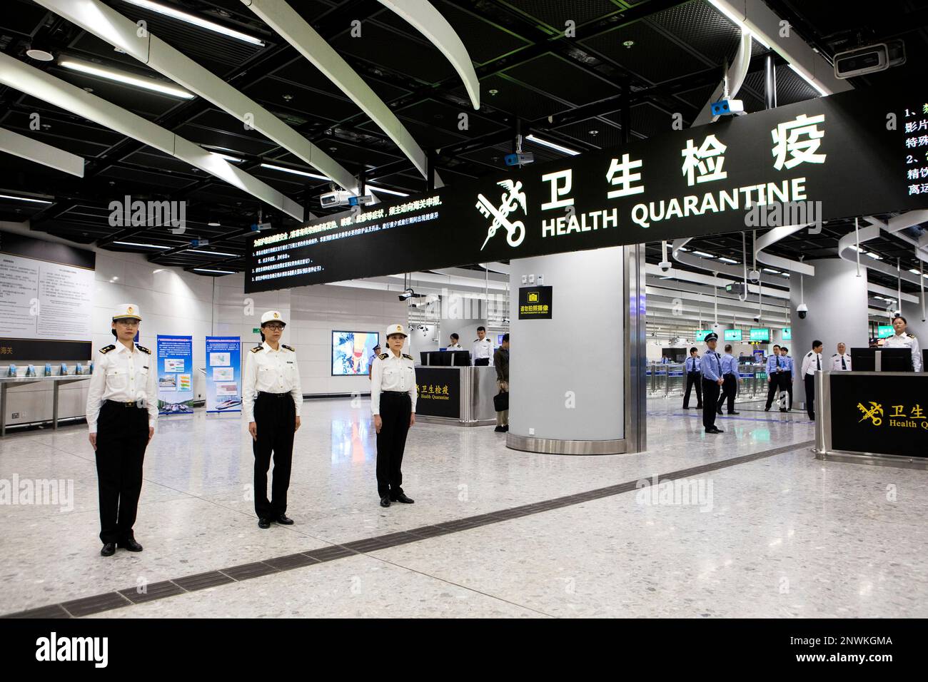 Officers stand under a Health Quarantine sign in the Mainland Port Area ...