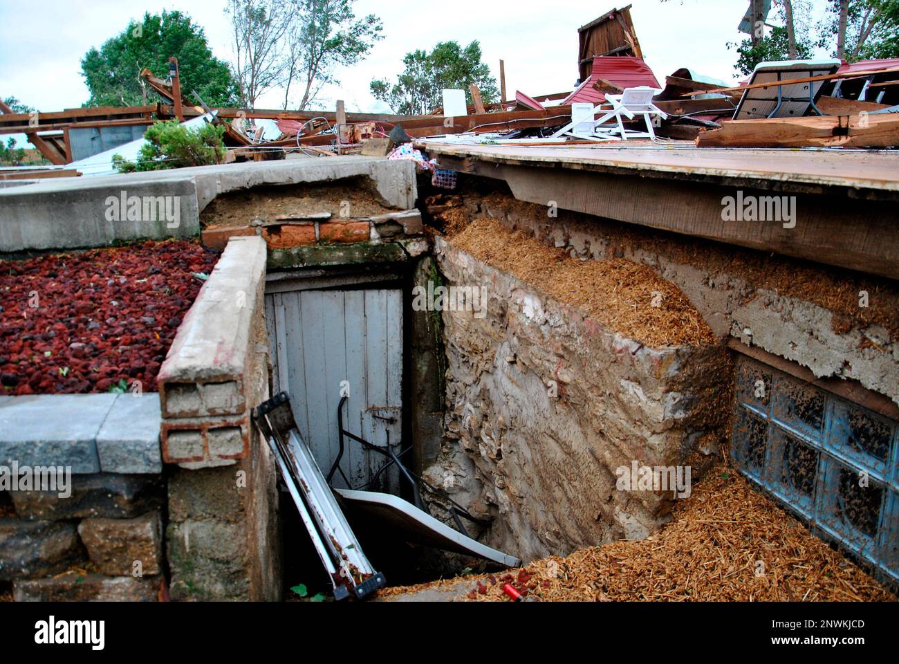 Various debris and items litter the grounds of Red Barn Farm which was ...
