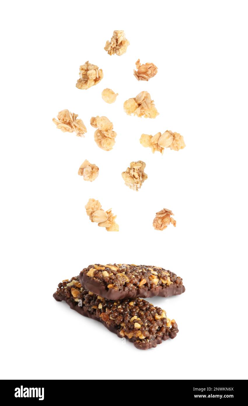 Tasty protein bars and granola falling on white background Stock Photo ...