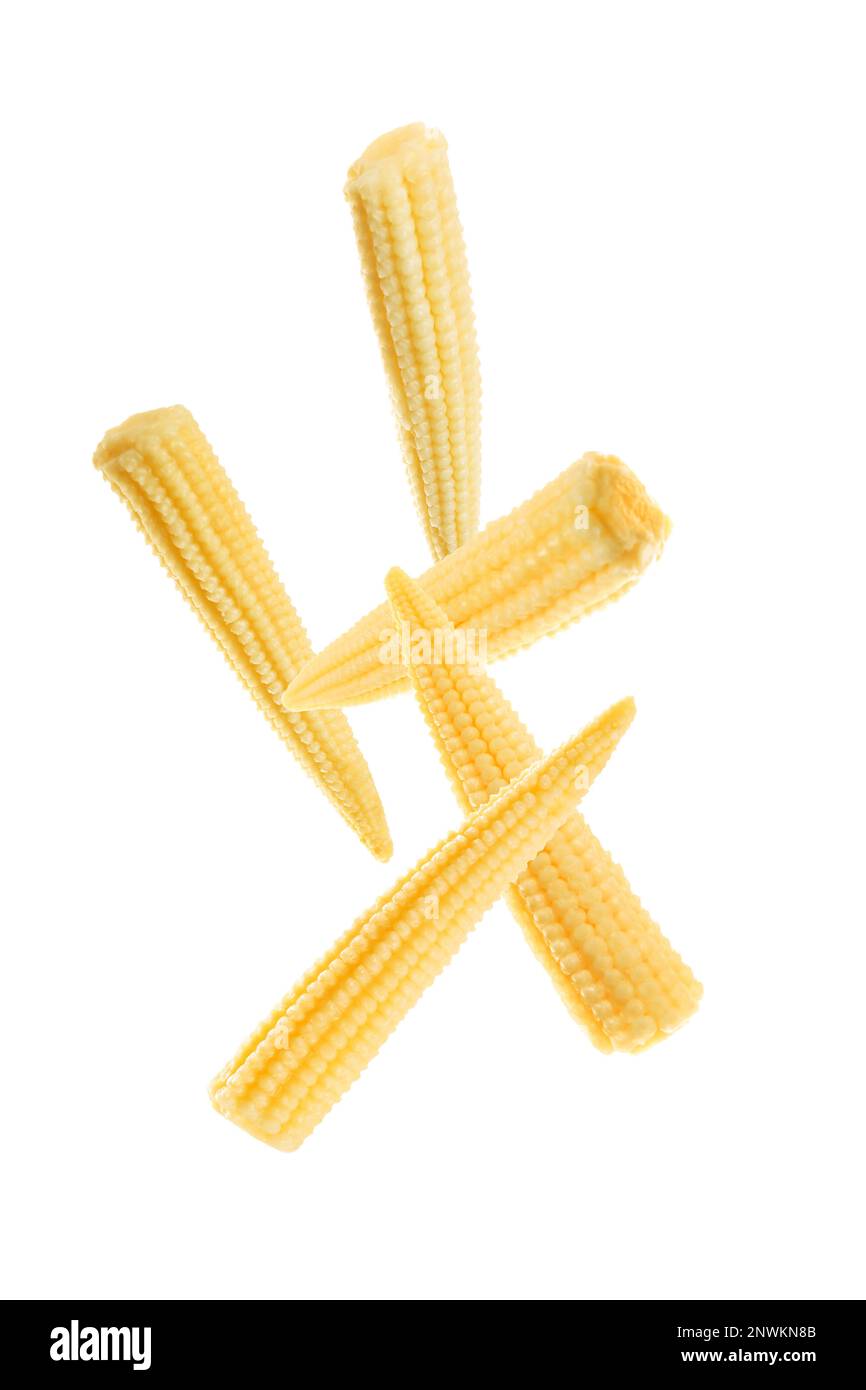 Tasty baby corn cobs flying on white background Stock Photo - Alamy