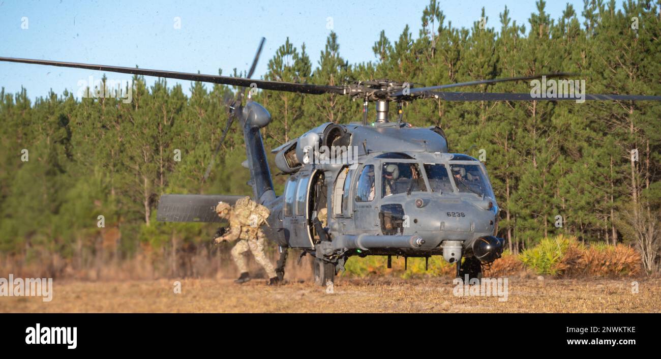A Tactical Control Party Airman exits from the back of an HH-60G Pave ...