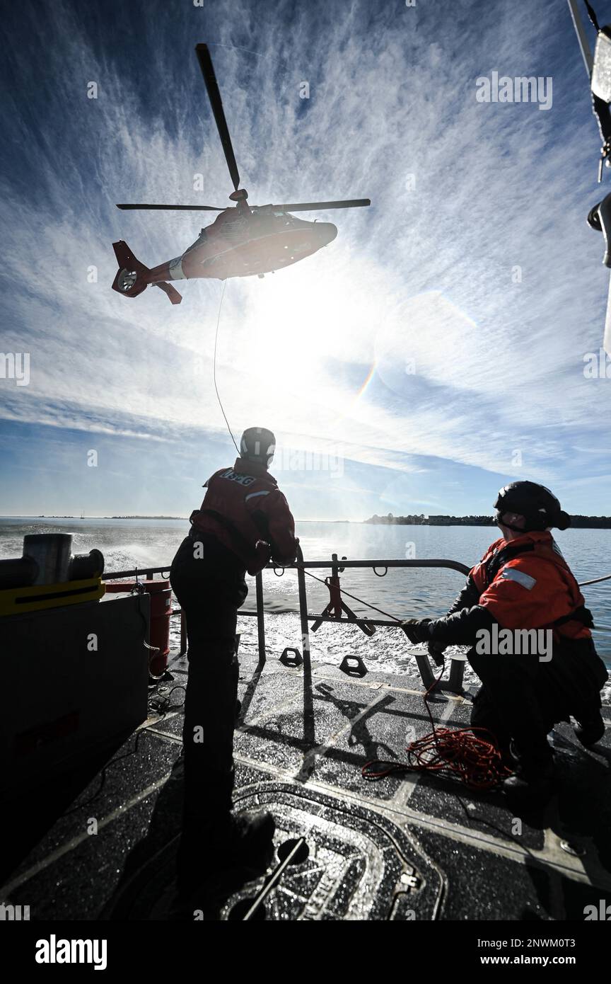 U.S. Coast Guard Seaman Eric Buckle, left, and Boatswains Mate 3rd ...