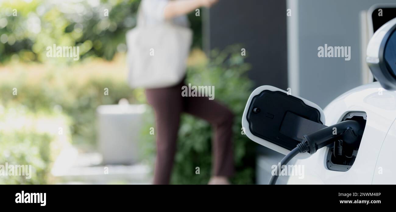 Focus EV charger plugged into EV car at home charging station with ...