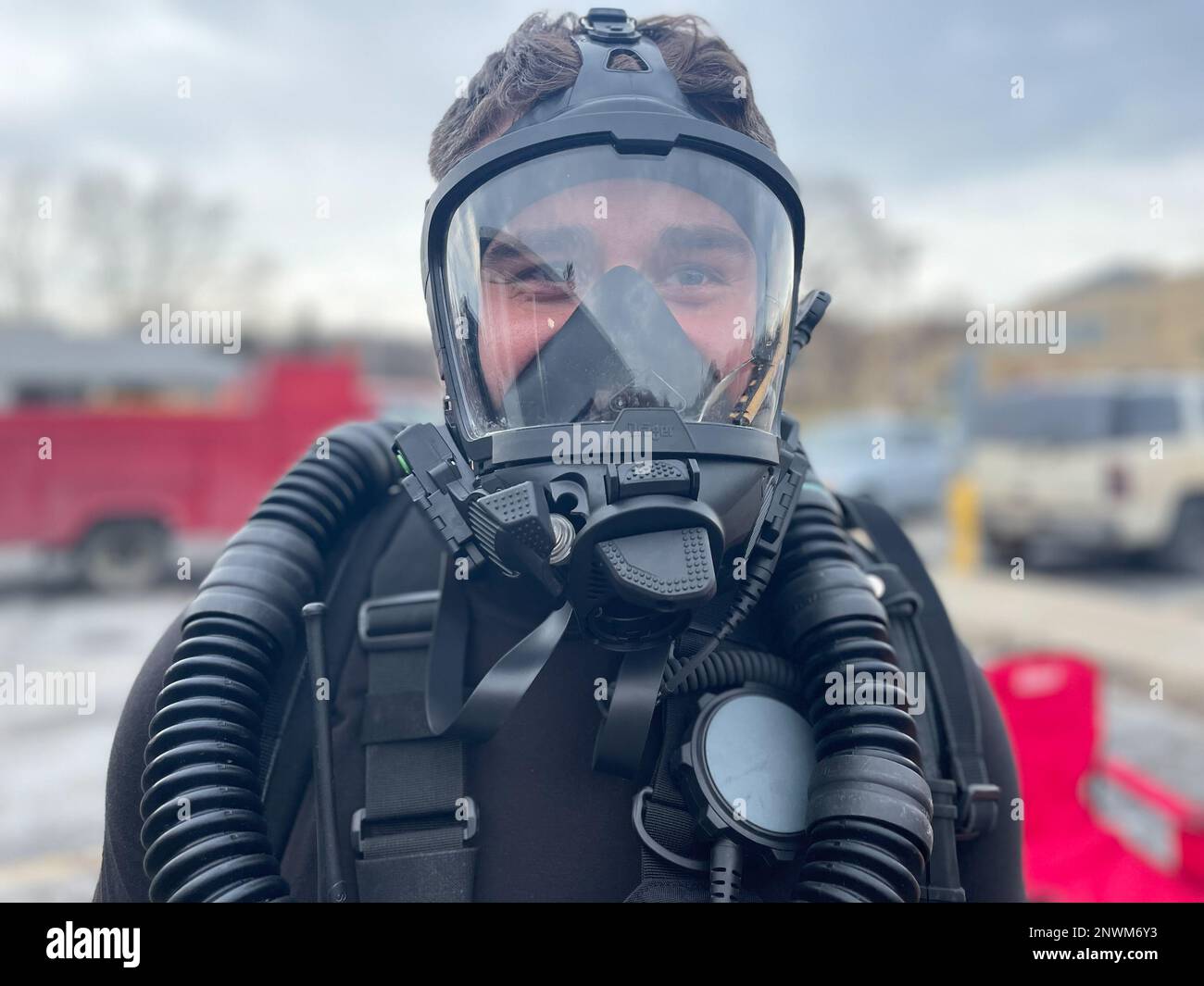 Master Sgt. Jaron Ross smiles through his protective mask prior to ...