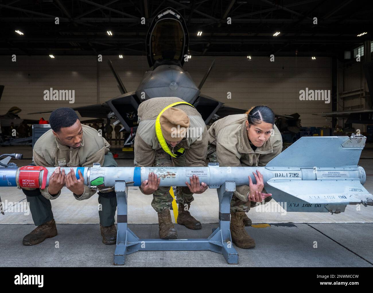 A 43rd Fighter Generation Squadron load crew work together to lift an ...