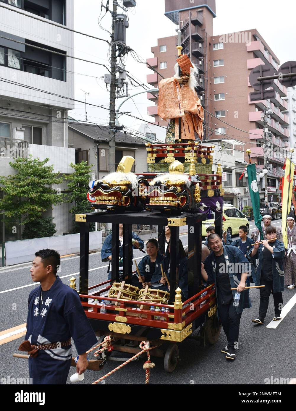 Participants parade with the portable shrine, a float, horses and ...