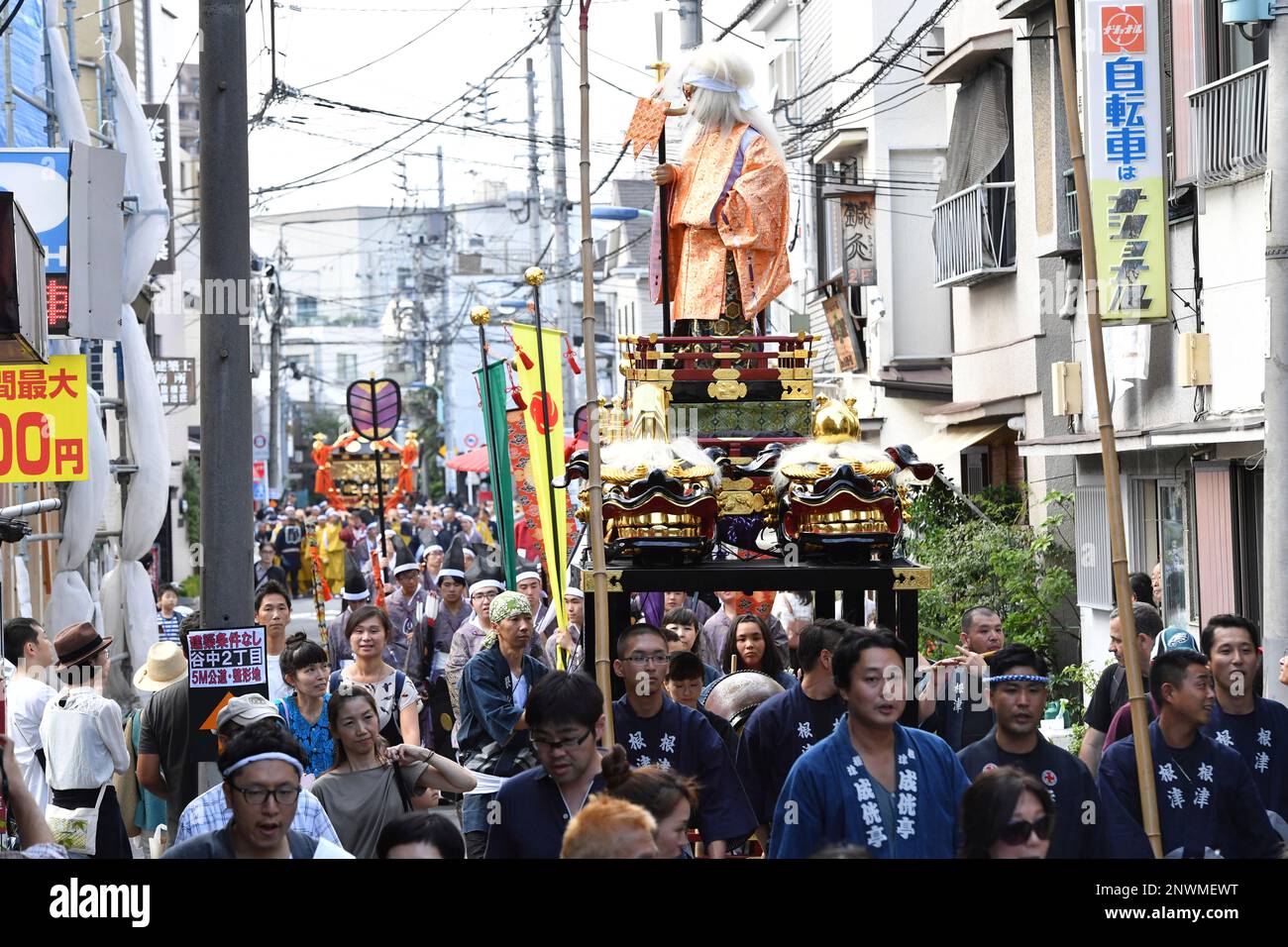 Participants parade with the portable shrine, a float, horses and ...