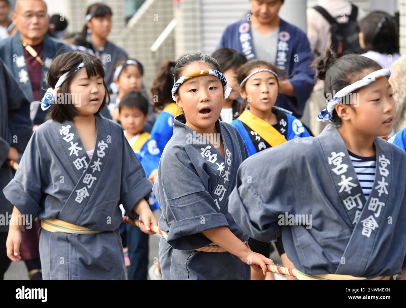 Participants parade with the portable shrine, a float, horses and ...