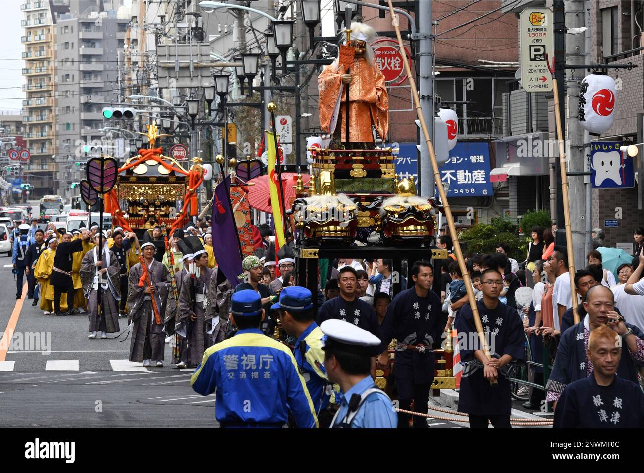Participants parade with the portable shrine, a float, horses and ...