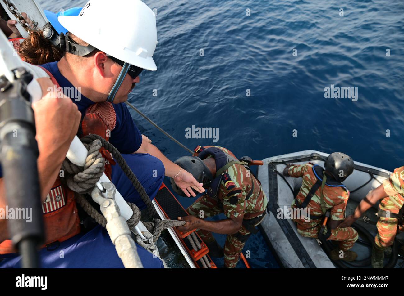 U.S. Coast Guard Chief Petty Officer James Booth assists Benin Navy ...