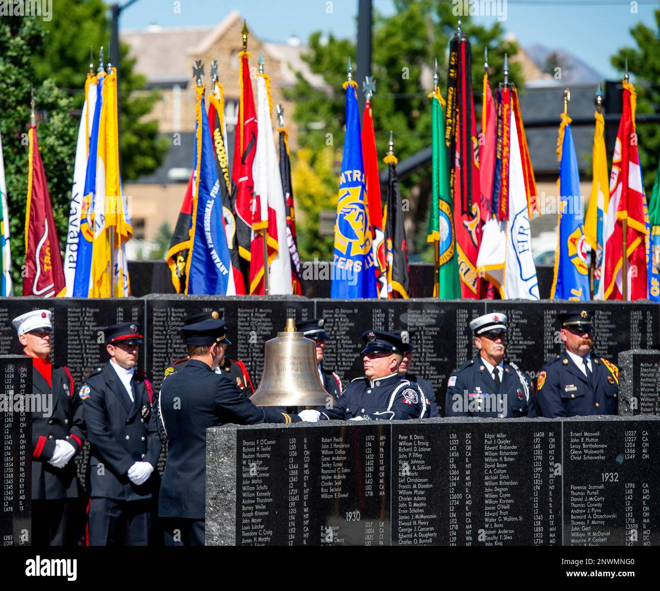 Honor guard members ring the bell each time a name is read during the ...