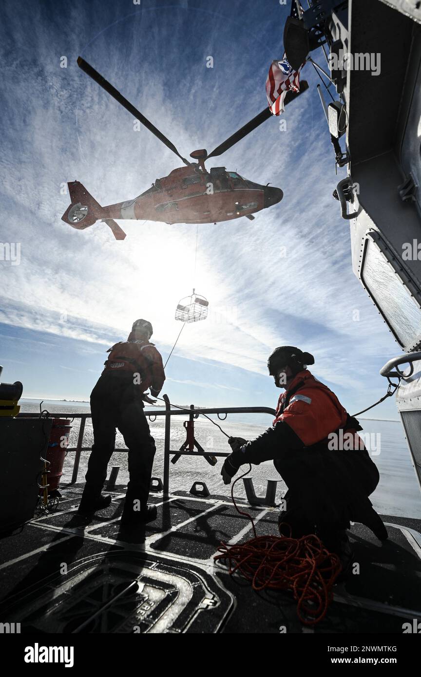 U.S. Coast Guard Seaman Eric Buckle, left, and Boatswains Mate 3rd ...