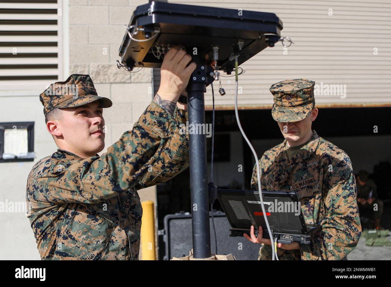 U.S. Marine Corps Cpl. Jonathan Aden, left, a special communications ...